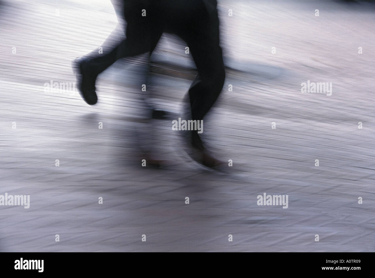 Businessman legs running down street Stock Photo - Alamy