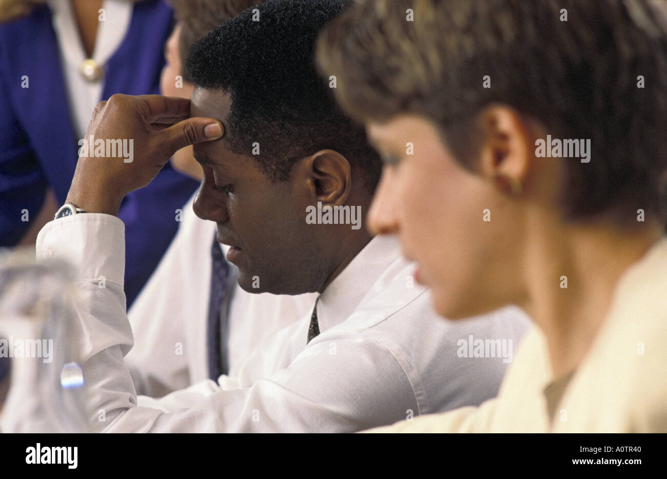African-American business executive concentrating during a management ...