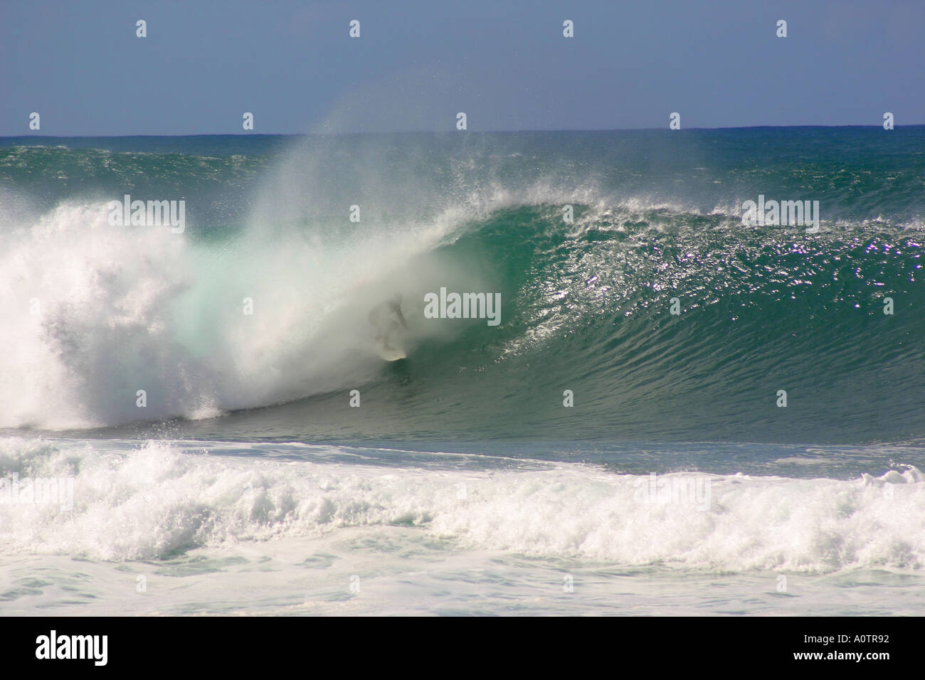 Surfer in the tube on massive curling wave Pipeline beach North Shore ...