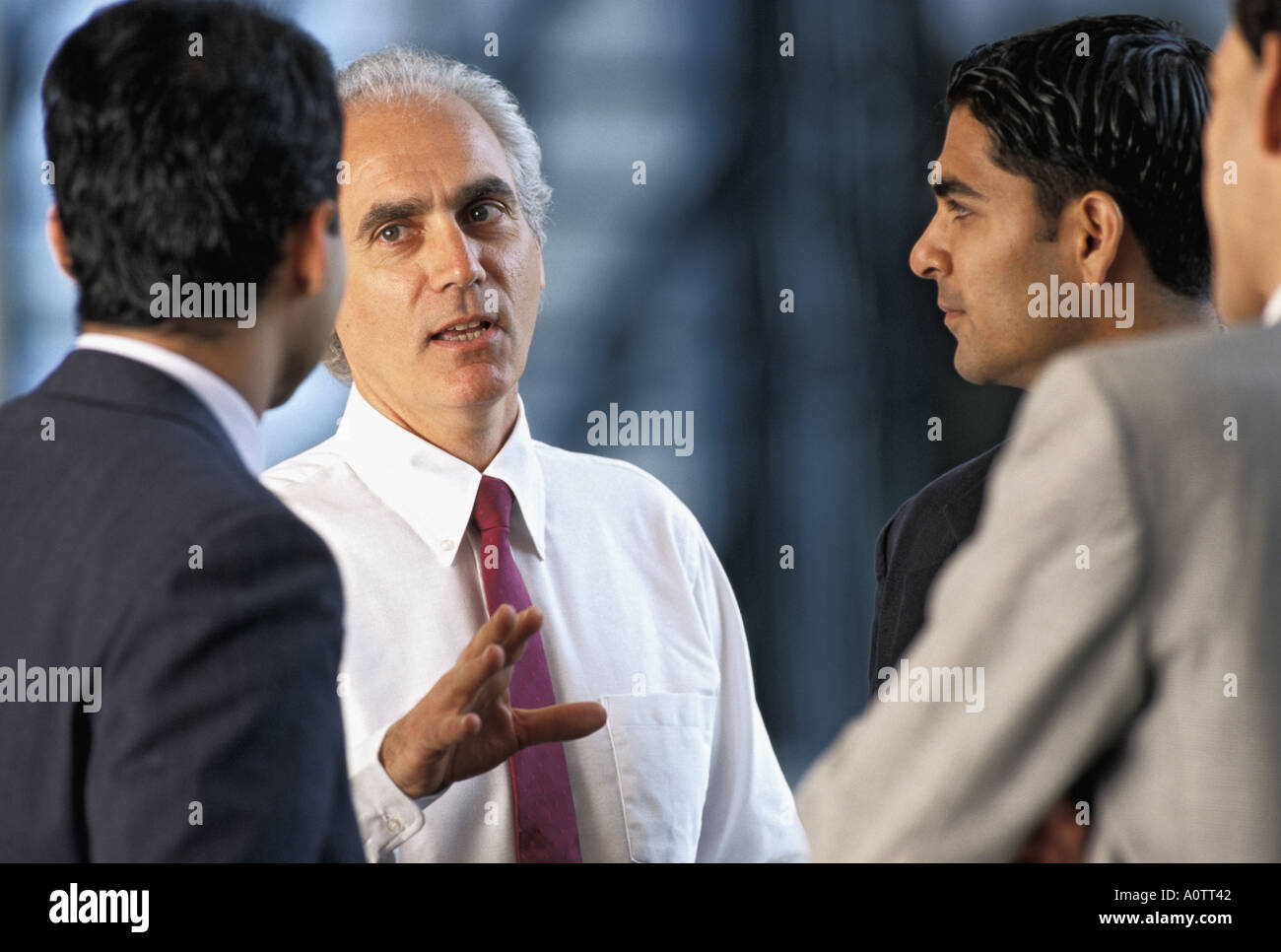 Teamwork between Hispanic and Caucasian executives planning a business ...