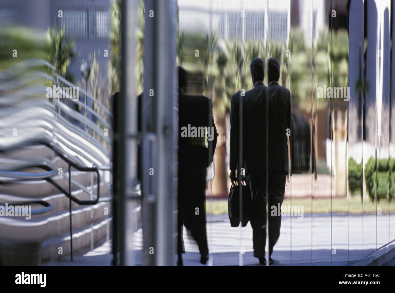 Abstract reflection in office building window of Caucasian businessman ...