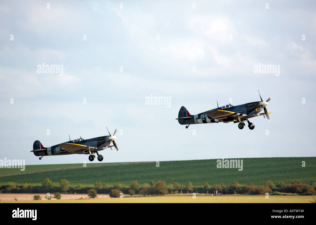Two Spitfires taking off from Duxford aerodrome Stock Photo - Alamy