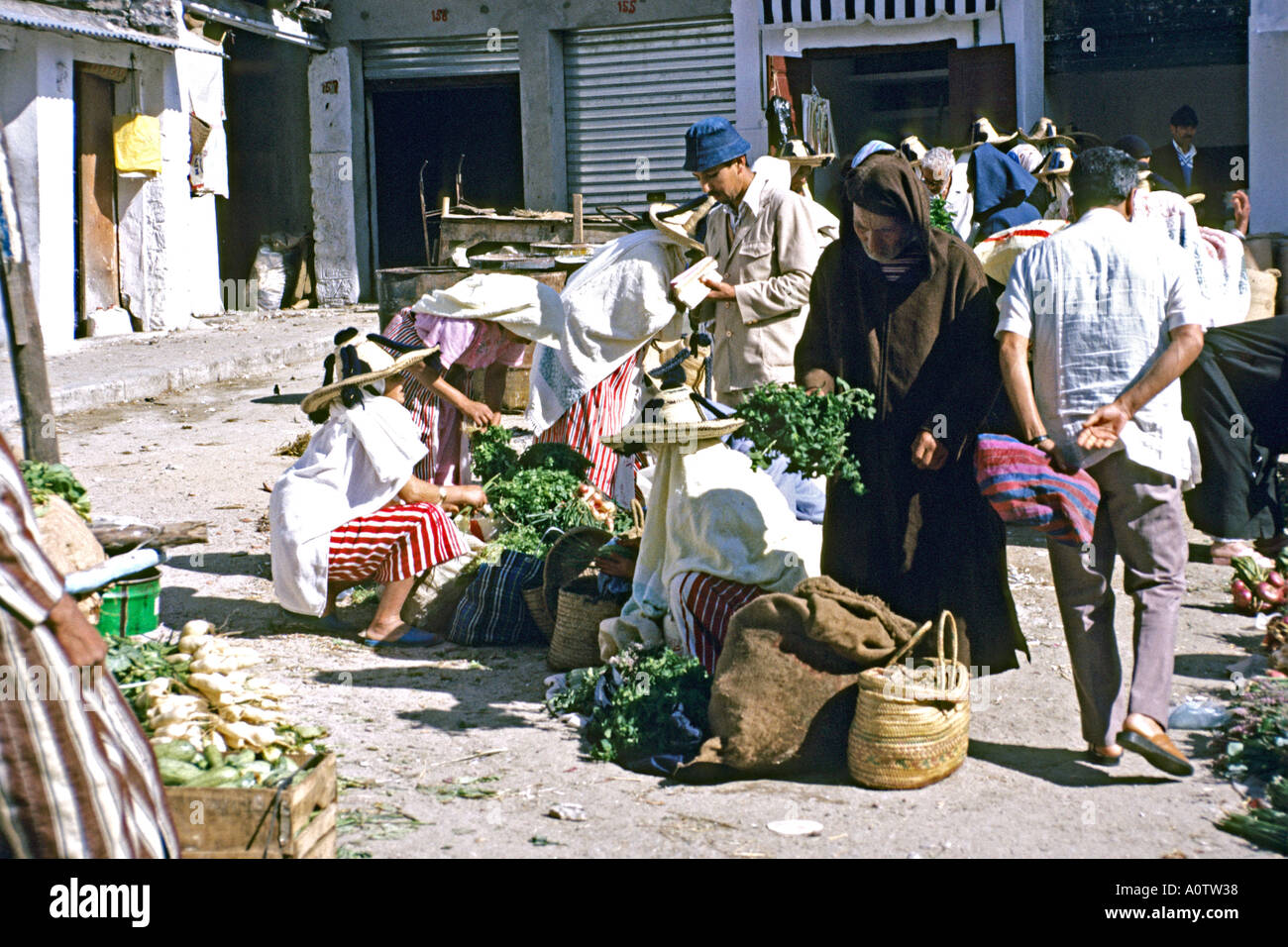 AFRICA MOROCCO TANGIER Berber women in traditional dress selling ...