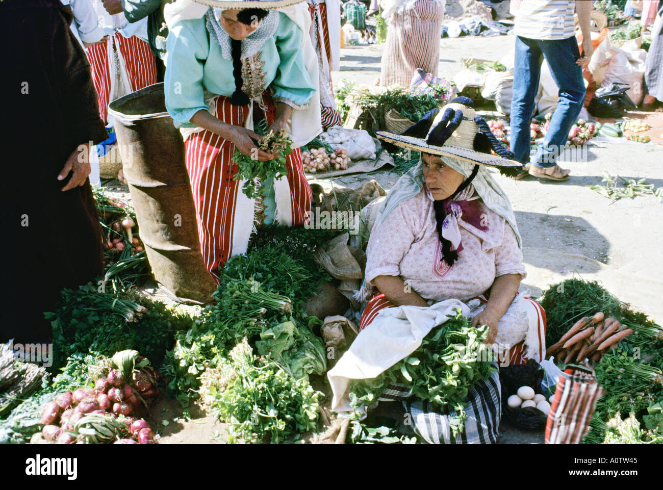 AFRICA MOROCCO TANGIER Berber women in traditional dress selling ...