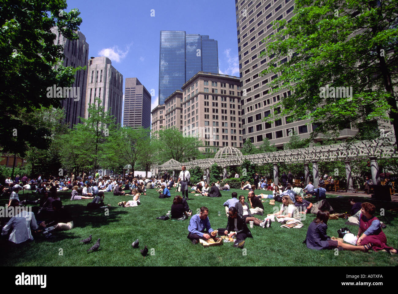Boston downtown city park lunch hour workers crowd lawn summer skyline ...