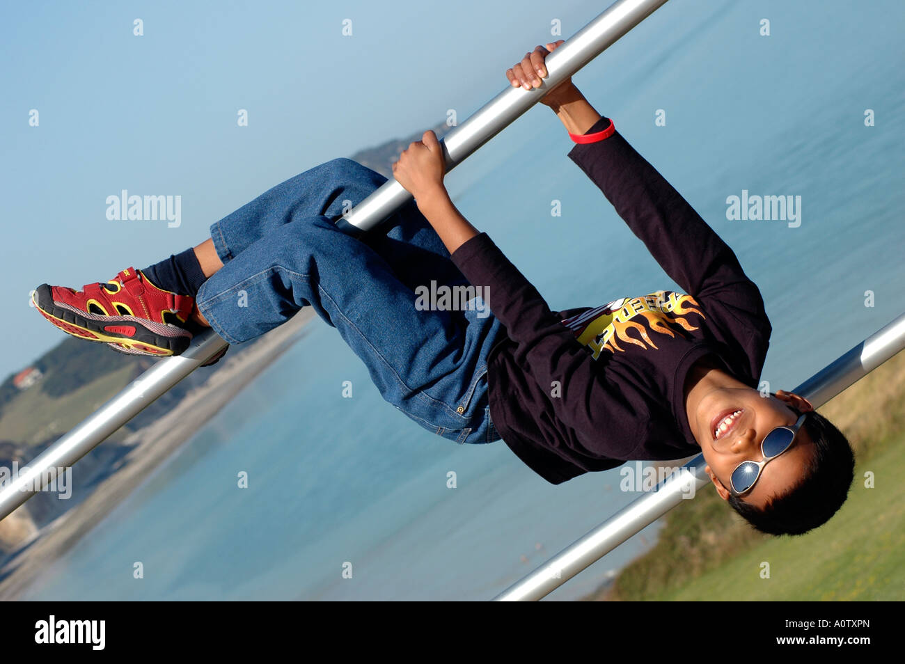 boy playing with railing,Normandie,France Stock Photo - Alamy