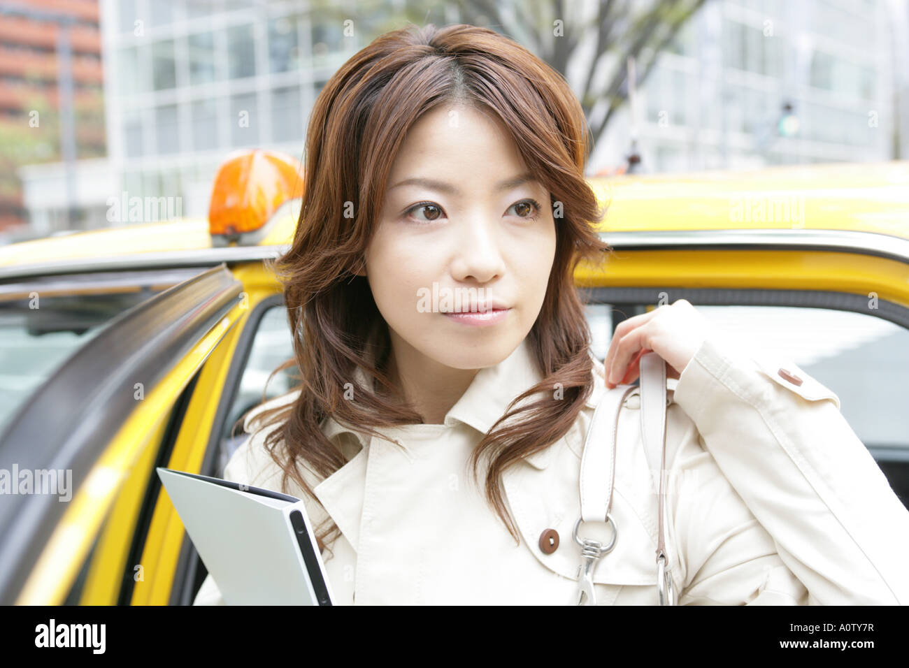Woman getting into yellow taxi hi-res stock photography and images - Alamy