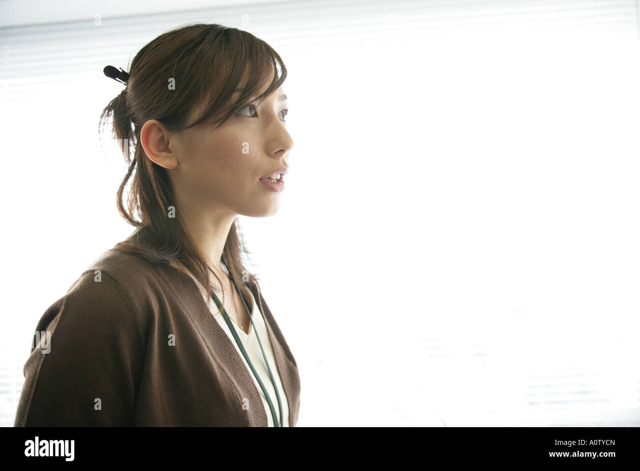 Side profile of a young woman staring Stock Photo - Alamy