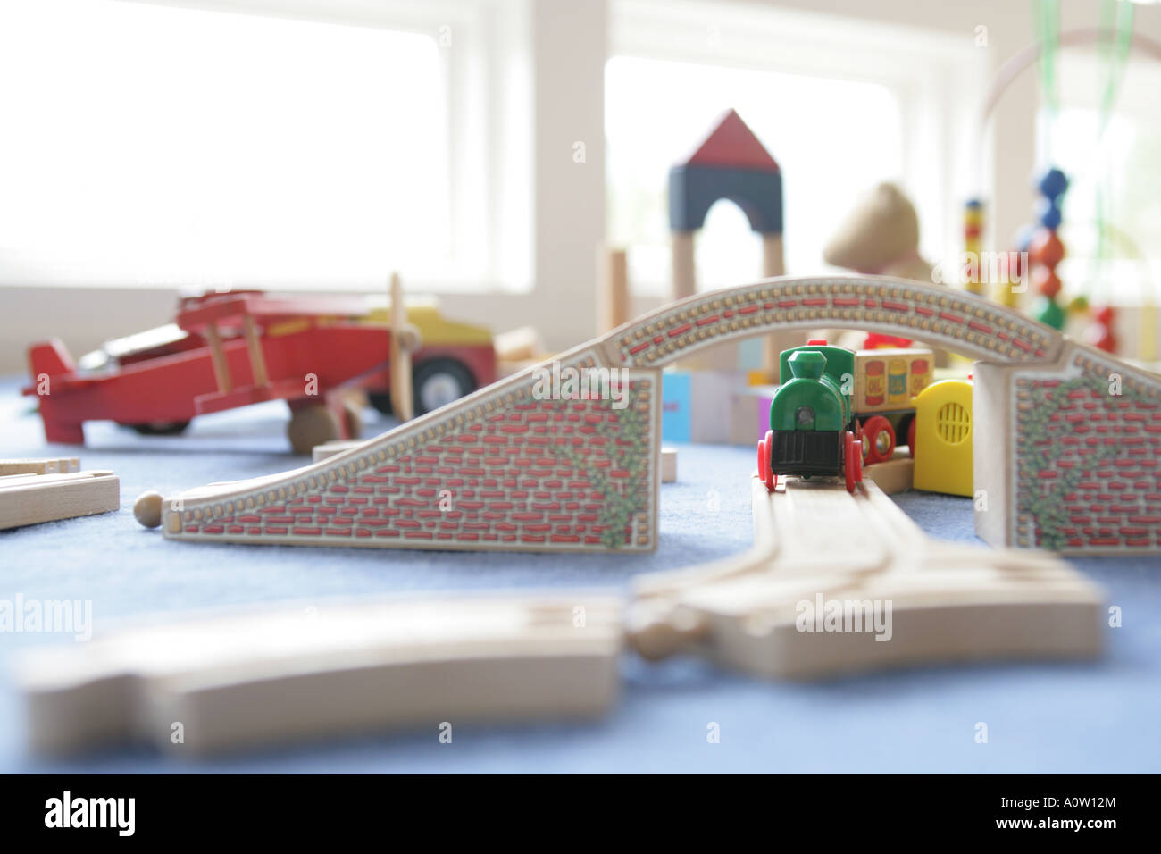 Model train passing under an overpass Stock Photo - Alamy