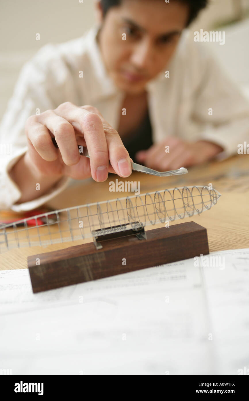 Young man assembling a model of an airship Stock Photo - Alamy