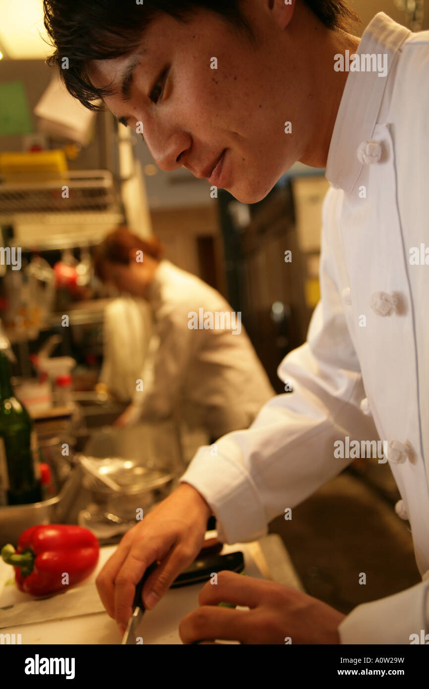 Side profile of a chef holding a knife in the kitchen Stock Photo - Alamy