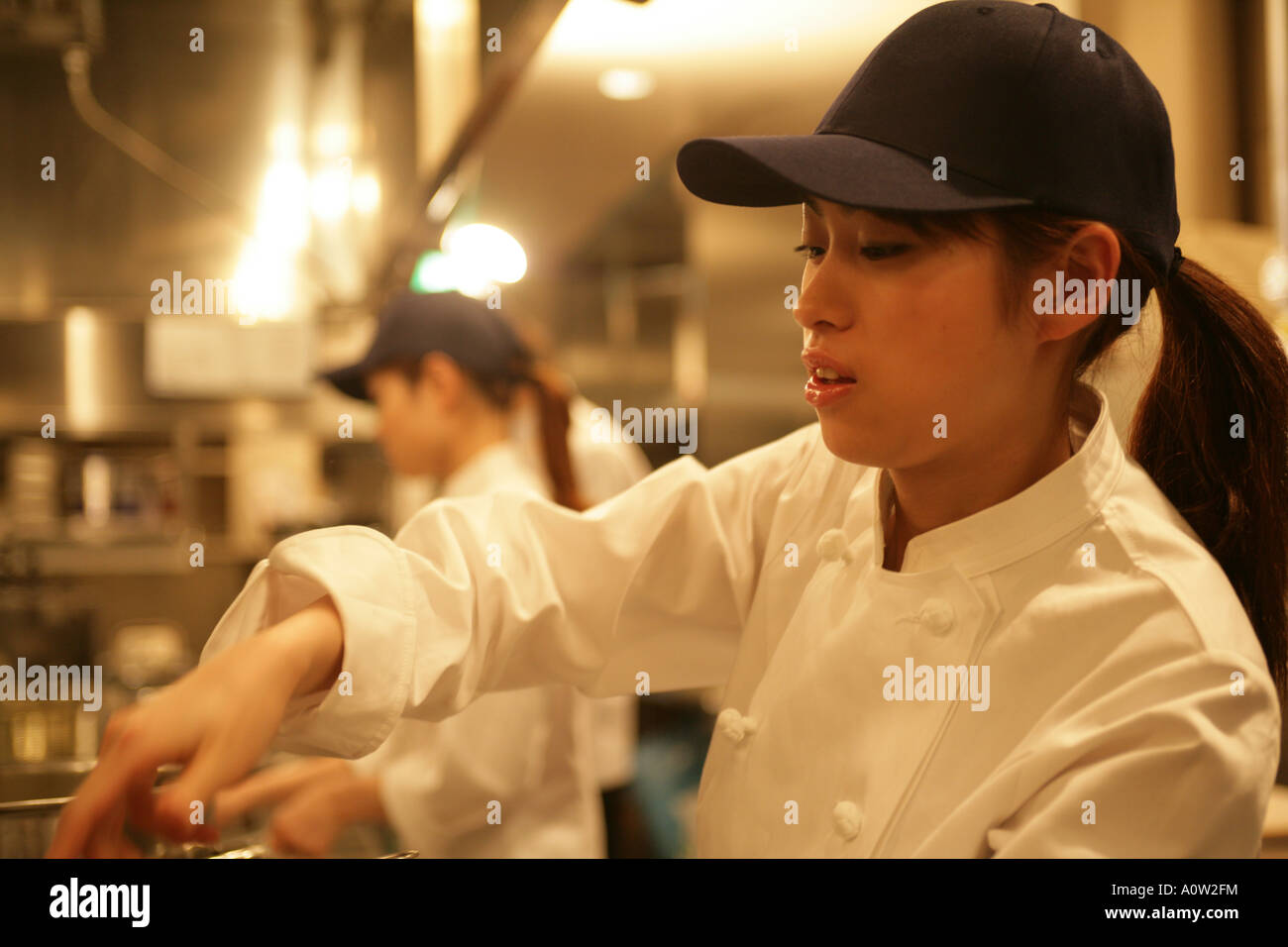 Back view female chef in hi-res stock photography and images - Alamy