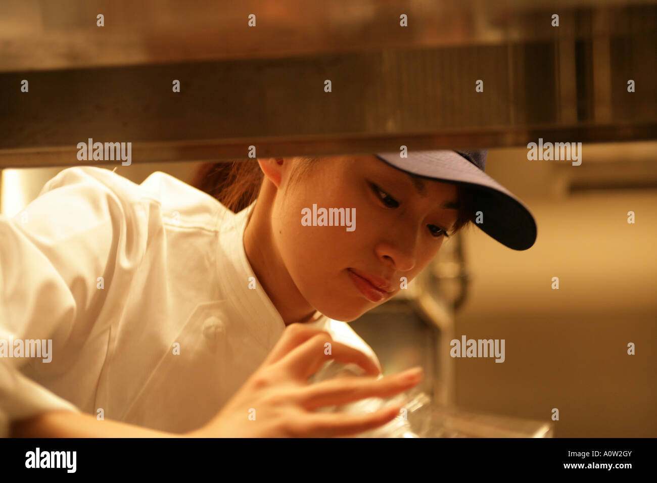 Close up of a waitress looking down Stock Photo - Alamy