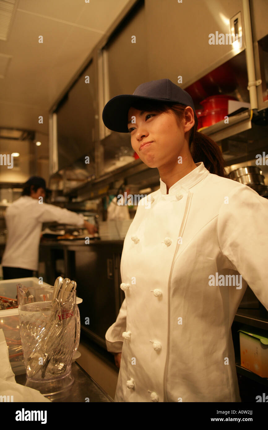 Close-up of a waitress standing in the kitchen Stock Photo - Alamy