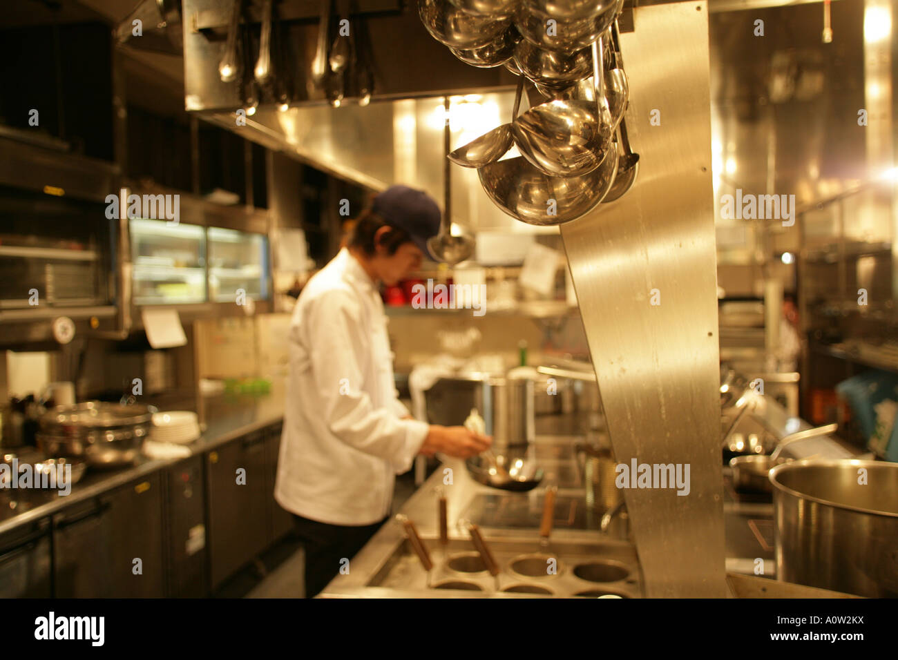 Side profile of a chef preparing food in the kitchen Stock Photo - Alamy