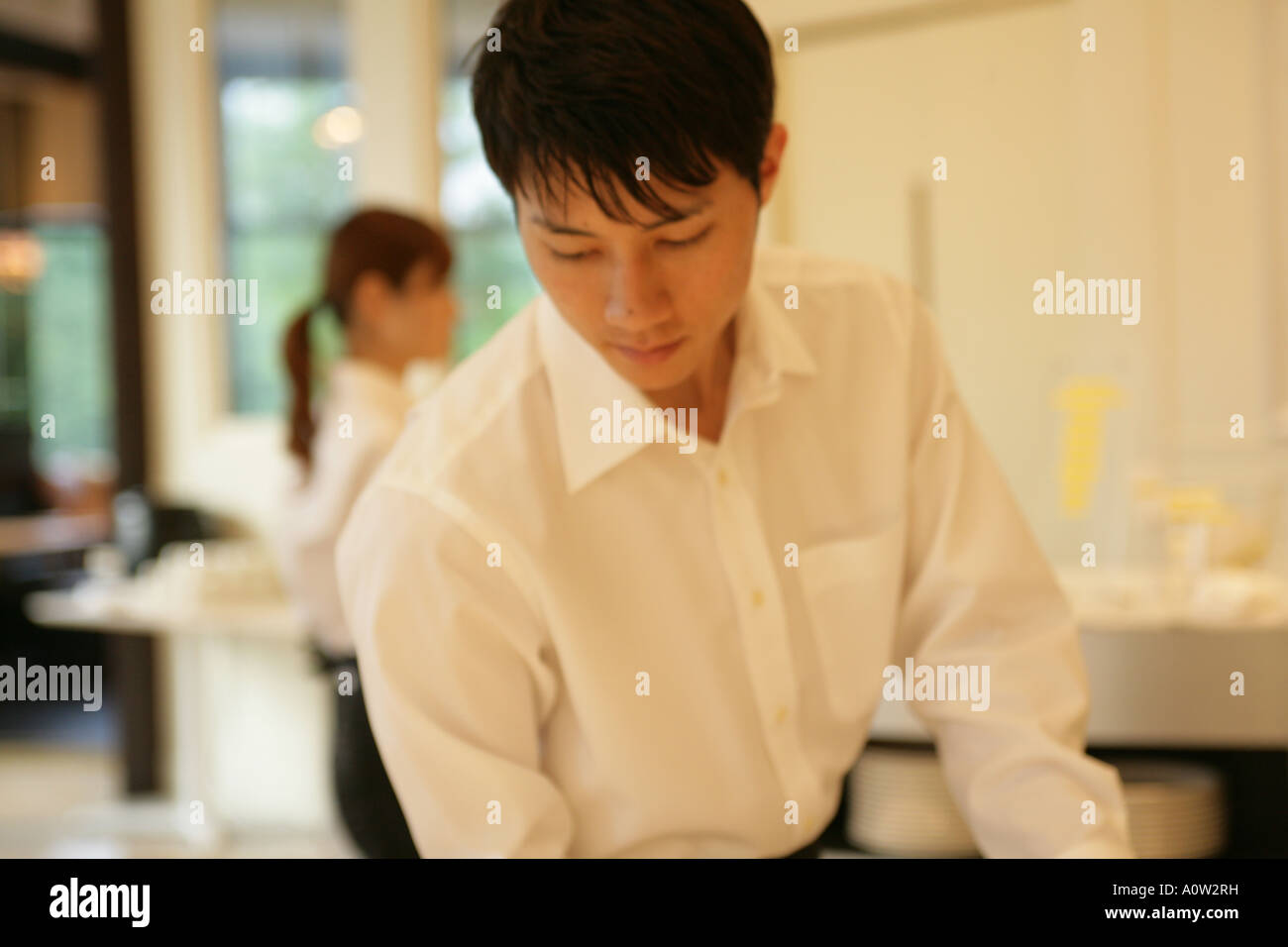 Close-Up of a waiter standing in a restaurant Stock Photo - Alamy
