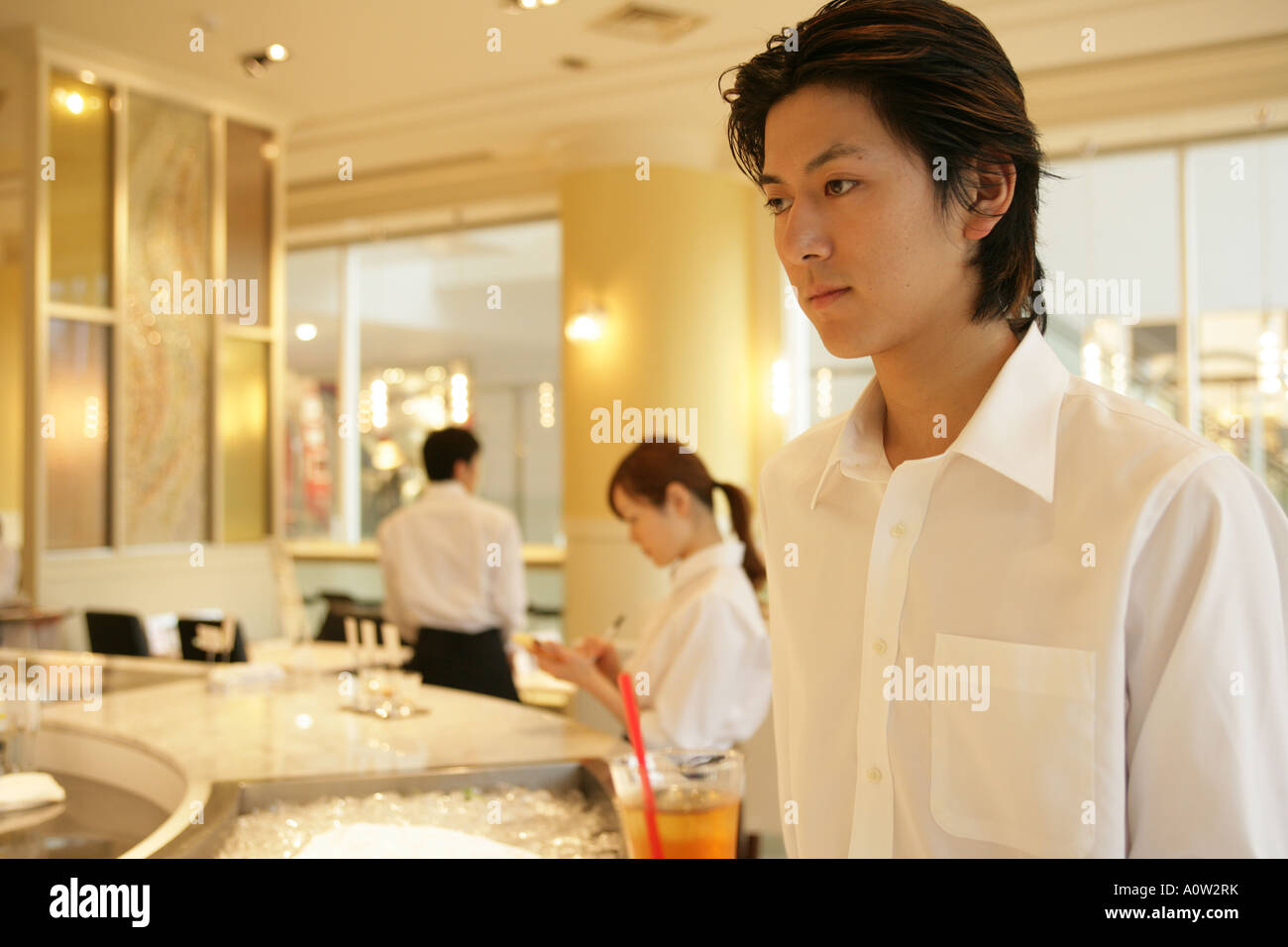 Close-Up of a waiter standing in a restaurant Stock Photo - Alamy