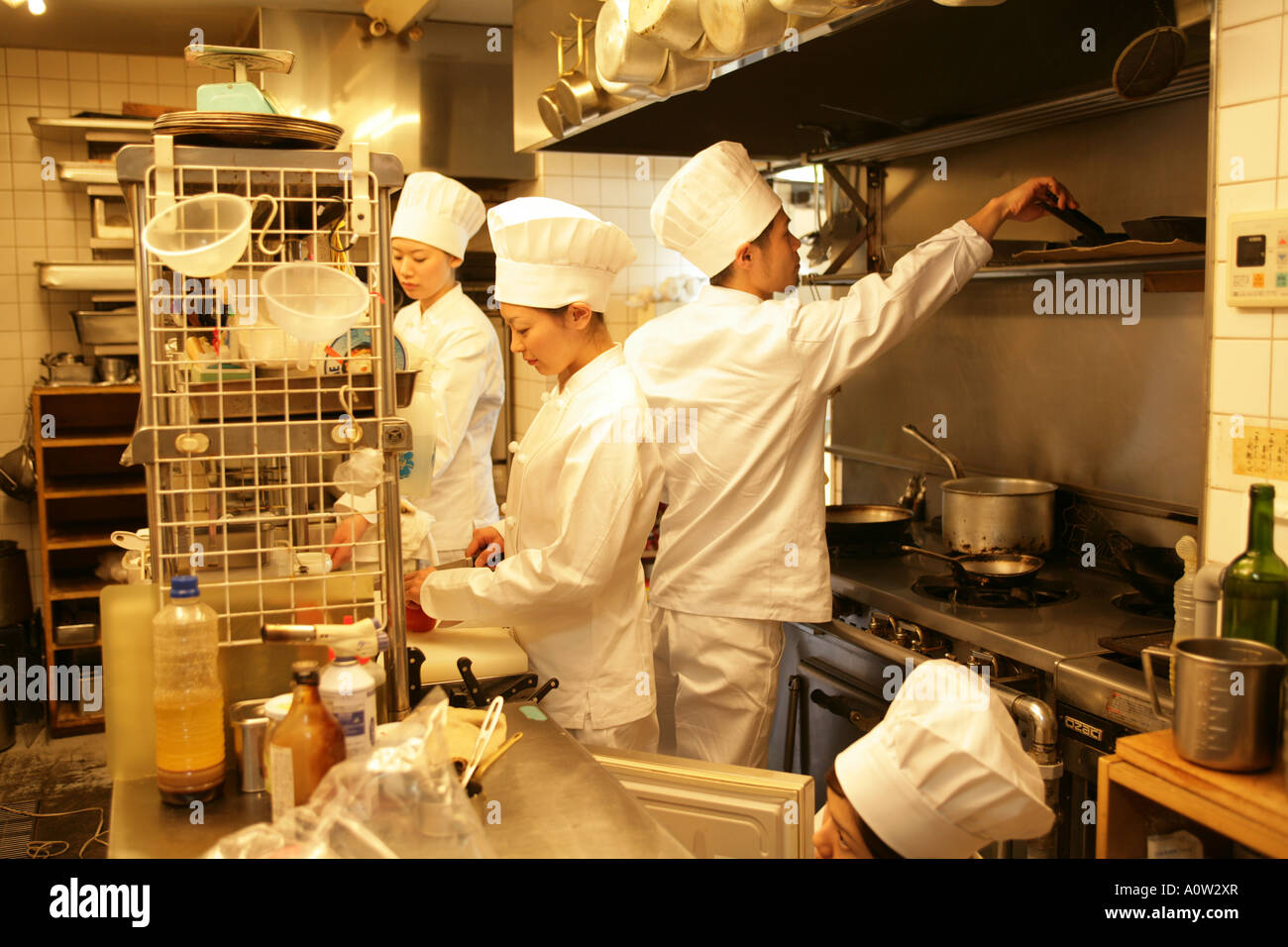Three female chefs and one male chef in the kitchen Stock Photo - Alamy