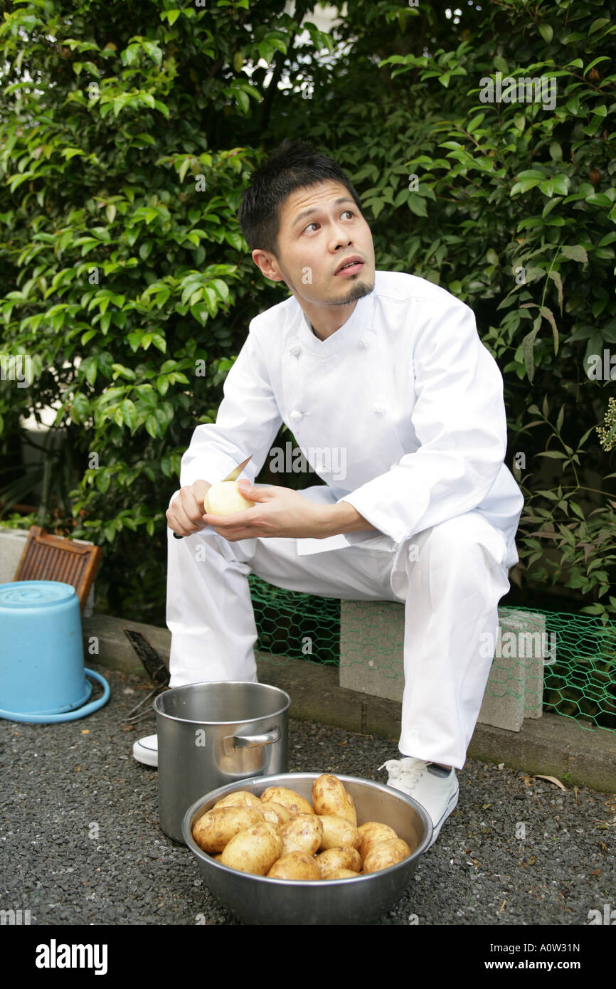Young man peeling potatoes hi-res stock photography and images - Alamy