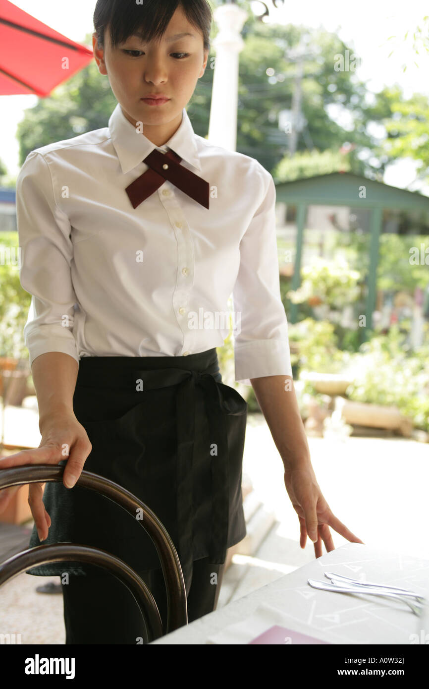 Close up of a waitress standing beside a table Stock Photo - Alamy