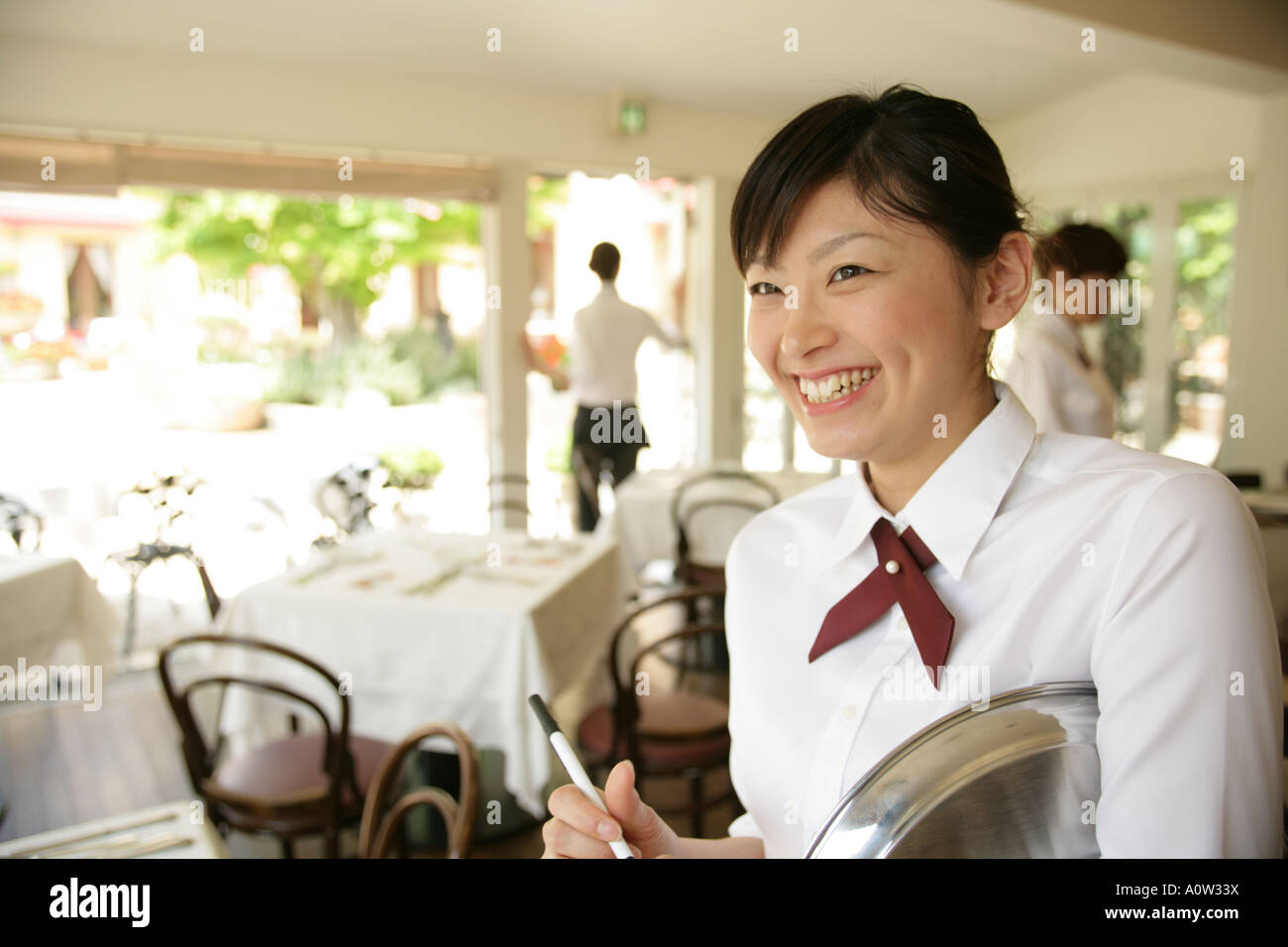 Close up of a waitress smiling Stock Photo - Alamy
