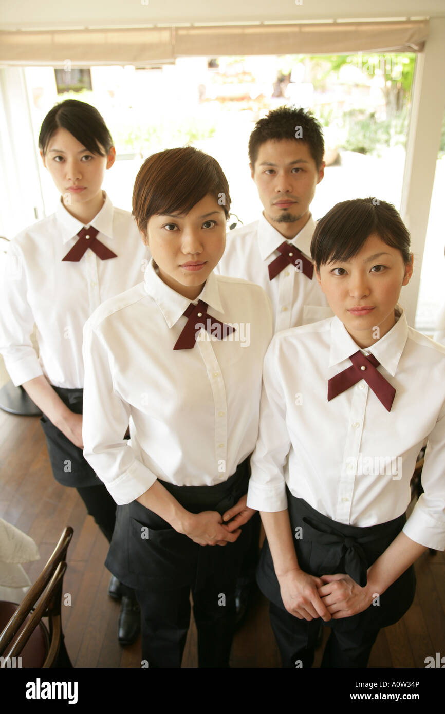 Portrait of a waiter and three waitresses Stock Photo - Alamy