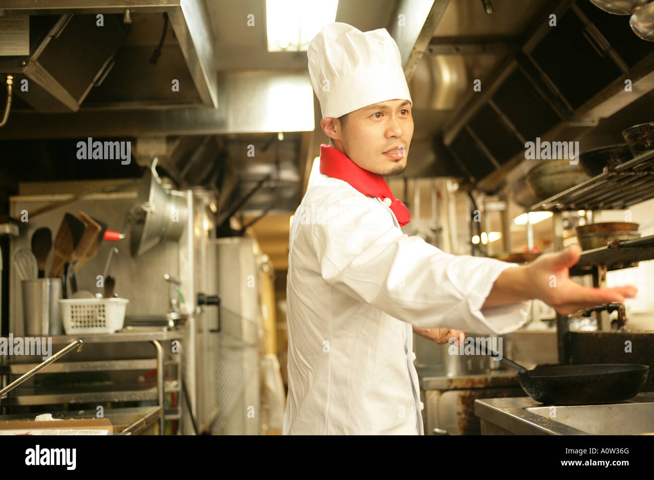 Side profile of a chef preparing food in the kitchen Stock Photo - Alamy