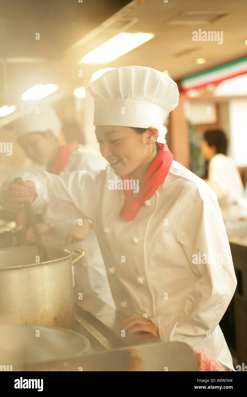 Female chef cooking in the kitchen Stock Photo - Alamy