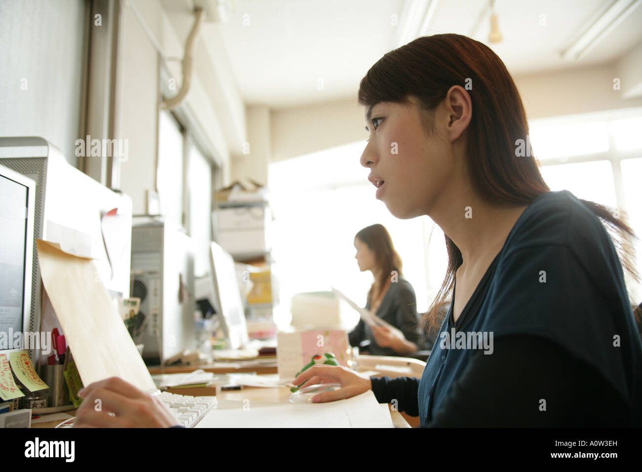Side profile of a businesswoman working on a computer Stock Photo - Alamy