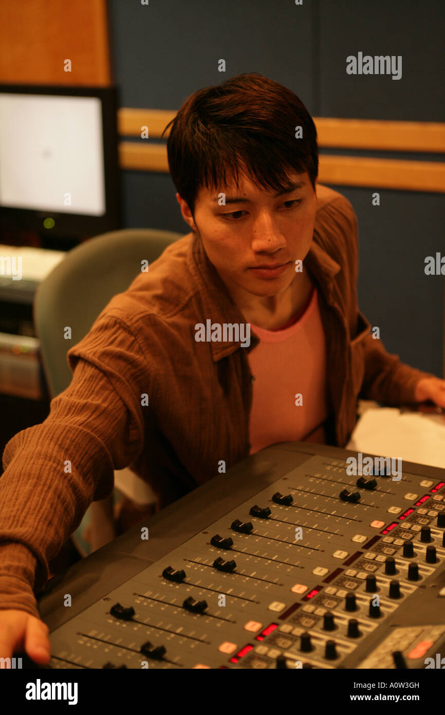 Young man operating a sound mixer Stock Photo - Alamy
