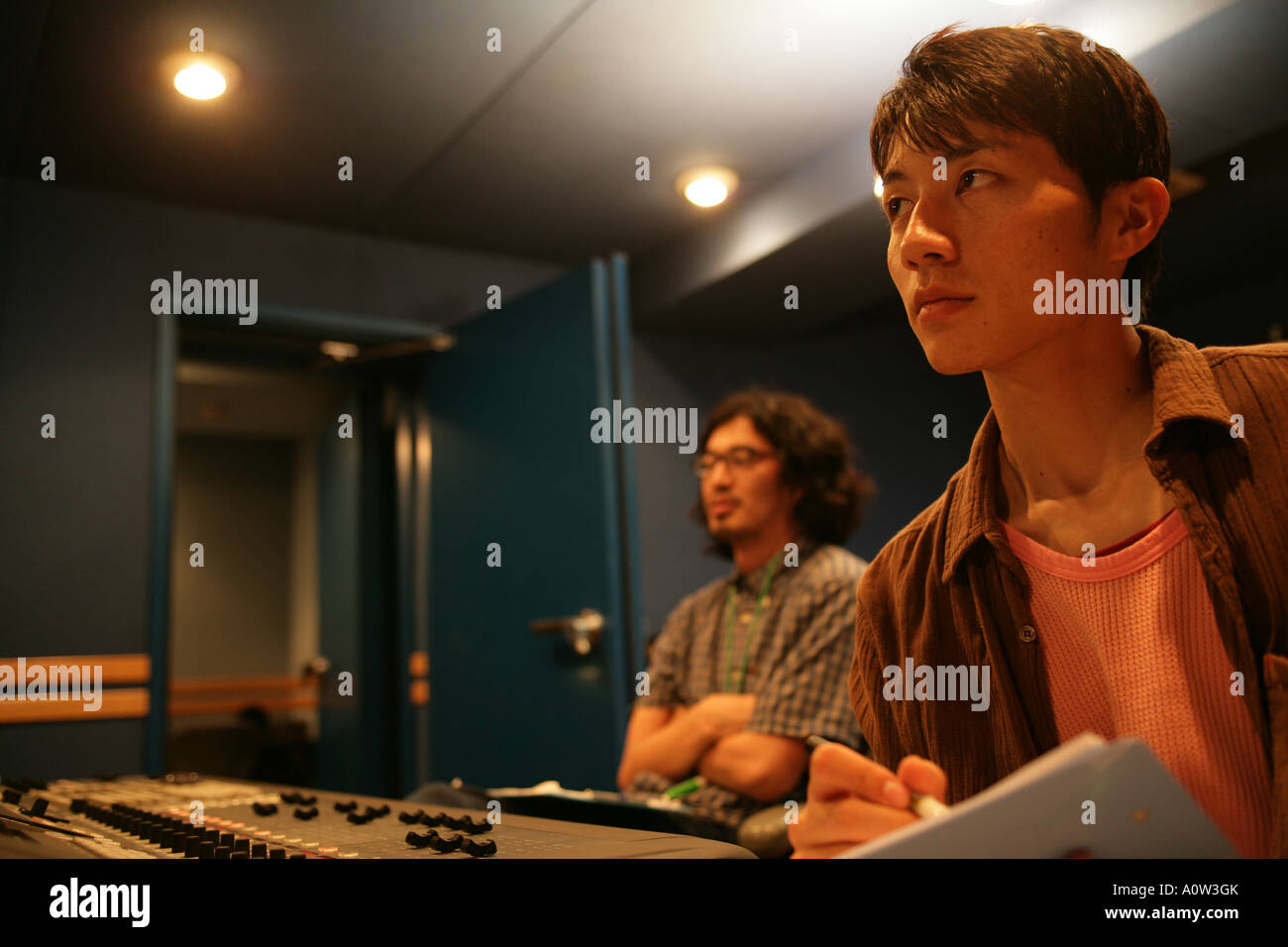 Two young men in a recording studio Stock Photo - Alamy