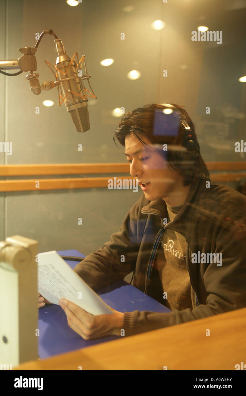 Side profile of a young man recording music in a recording studio Stock ...