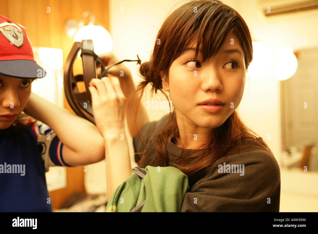 Close-up of fashion designer and female fashion model in dressing room ...
