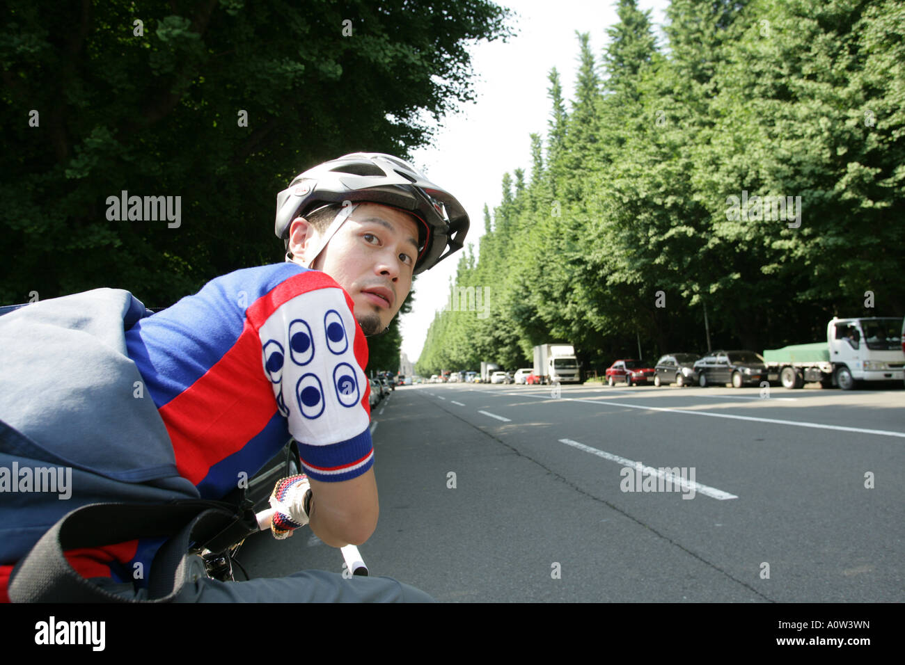 Side profile of a young man riding a bicycle Stock Photo - Alamy