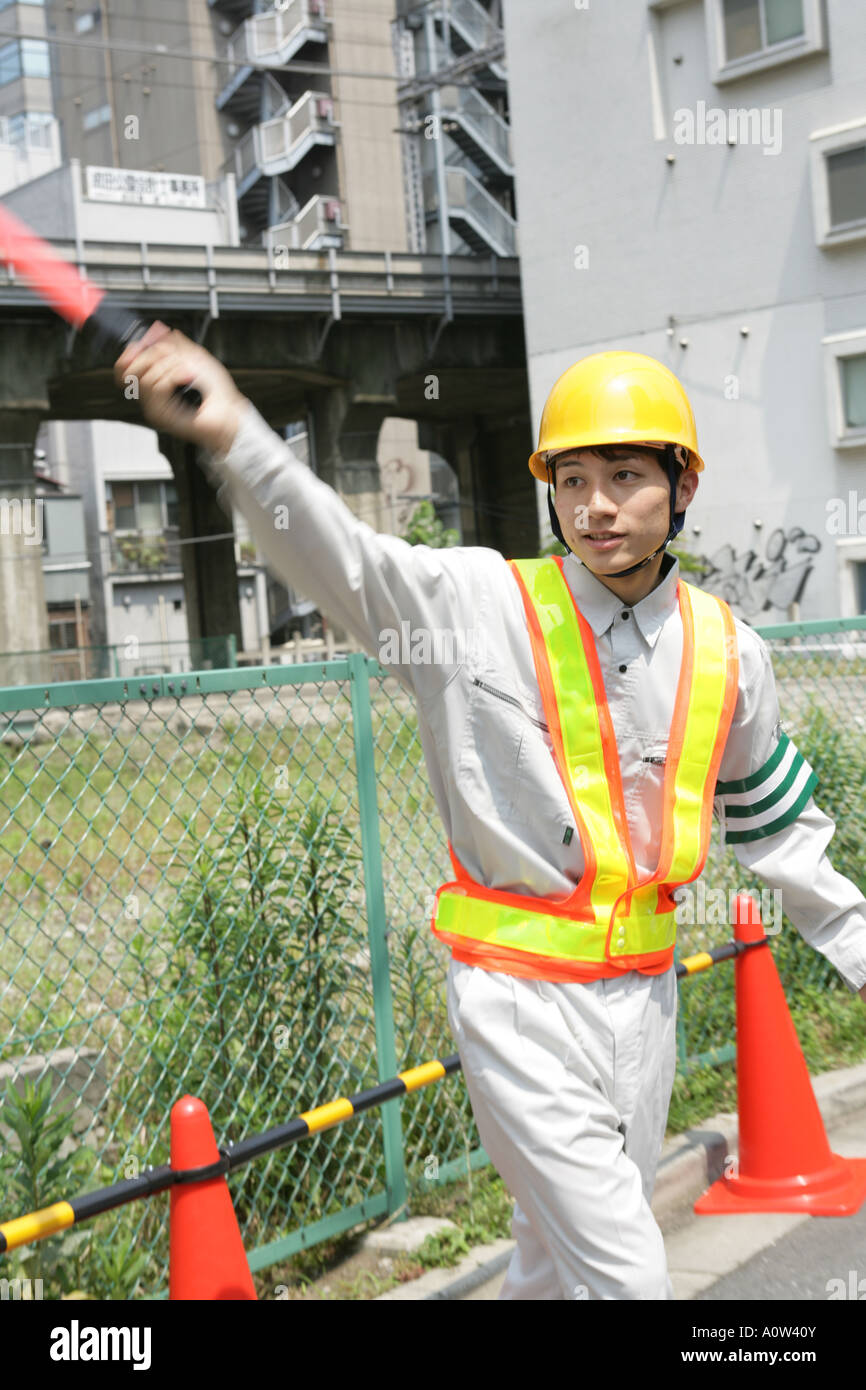 Traffic cop directing traffic with a nightstick Stock Photo - Alamy
