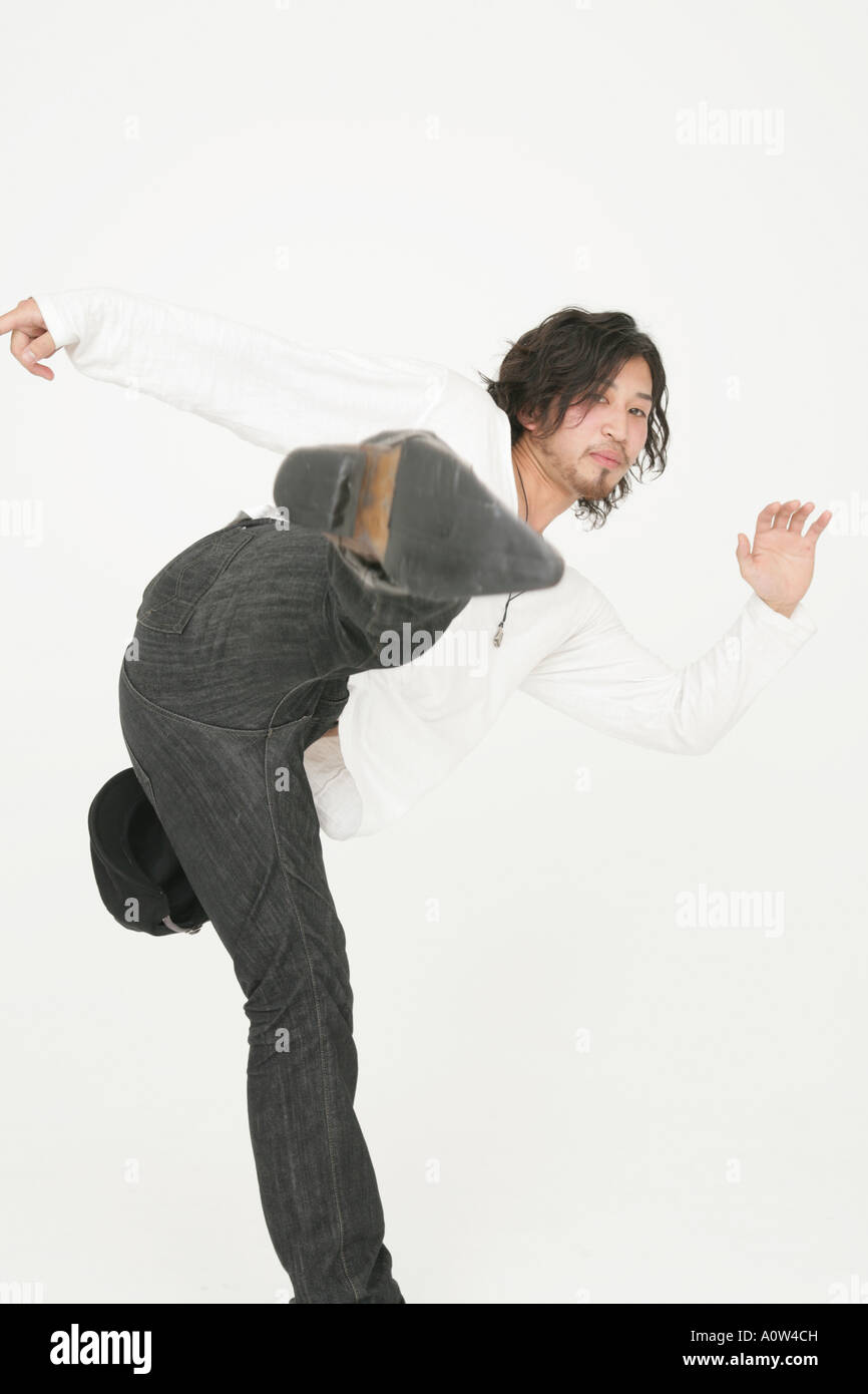 Portrait of a young man kicking Stock Photo - Alamy