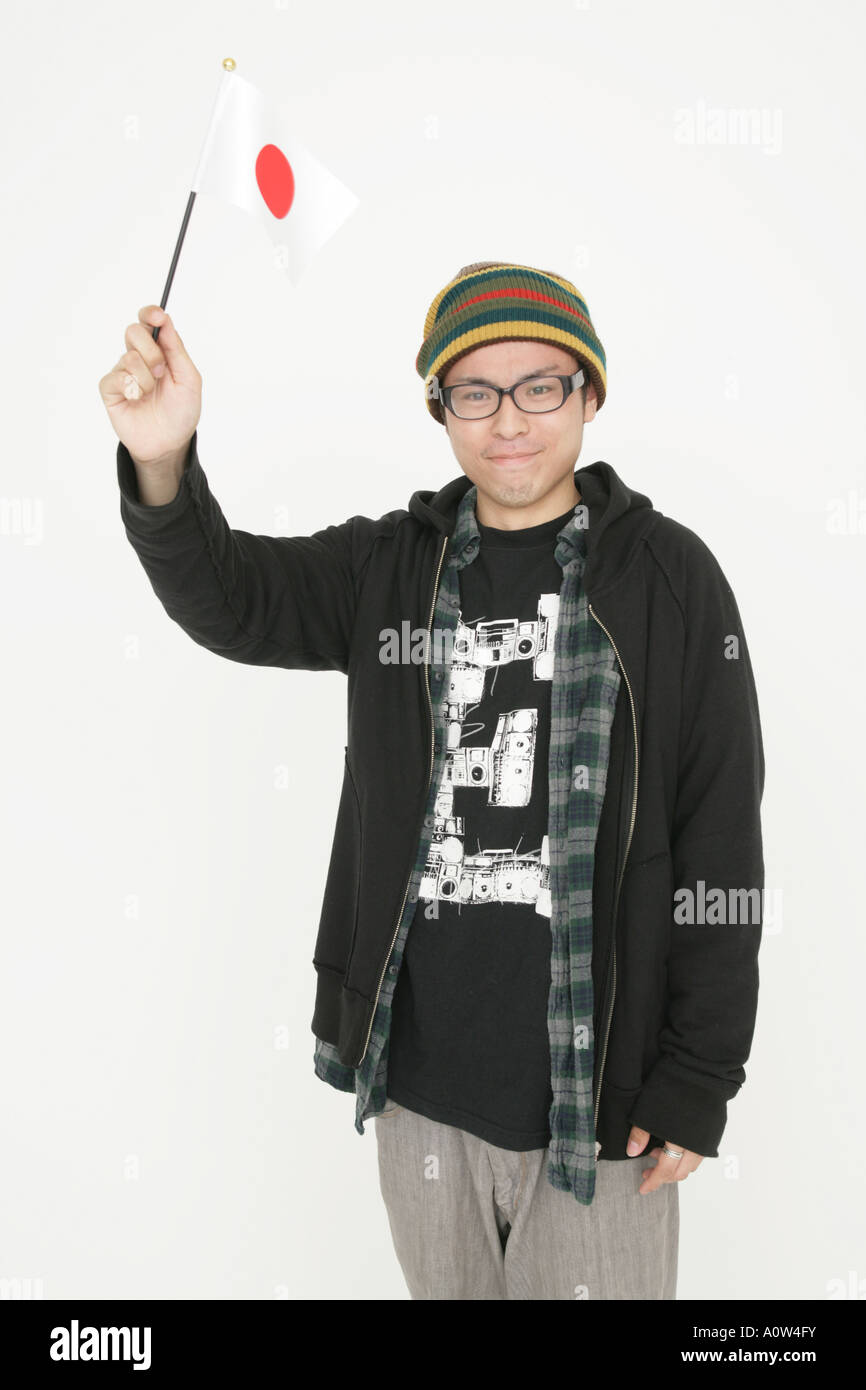 Portrait of a young man holding a Japanese Flag Stock Photo - Alamy