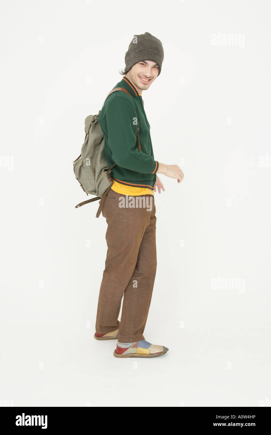 Portrait of a young man carrying a backpack and smiling Stock Photo - Alamy