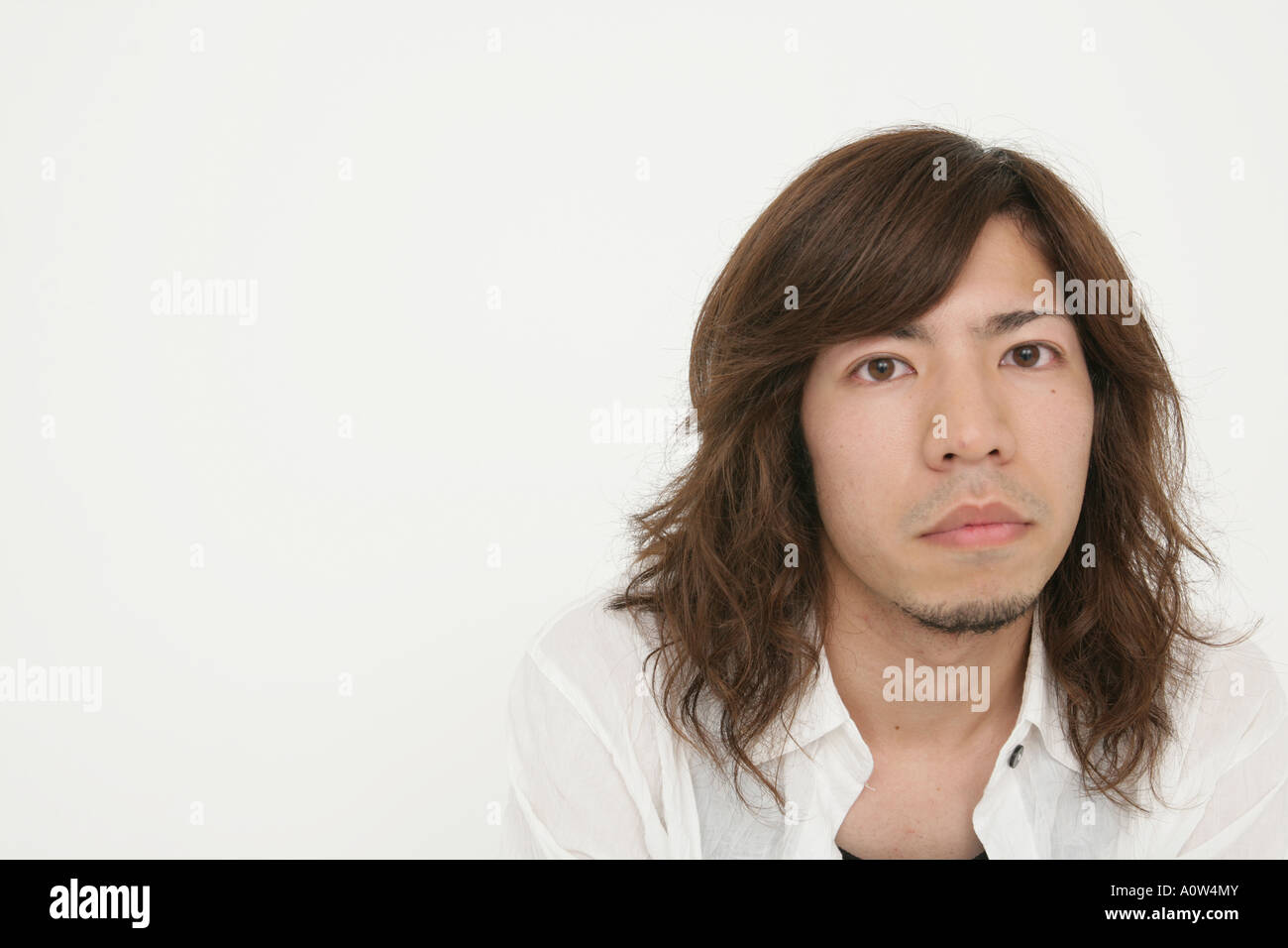 Portrait of a young man looking serious Stock Photo - Alamy