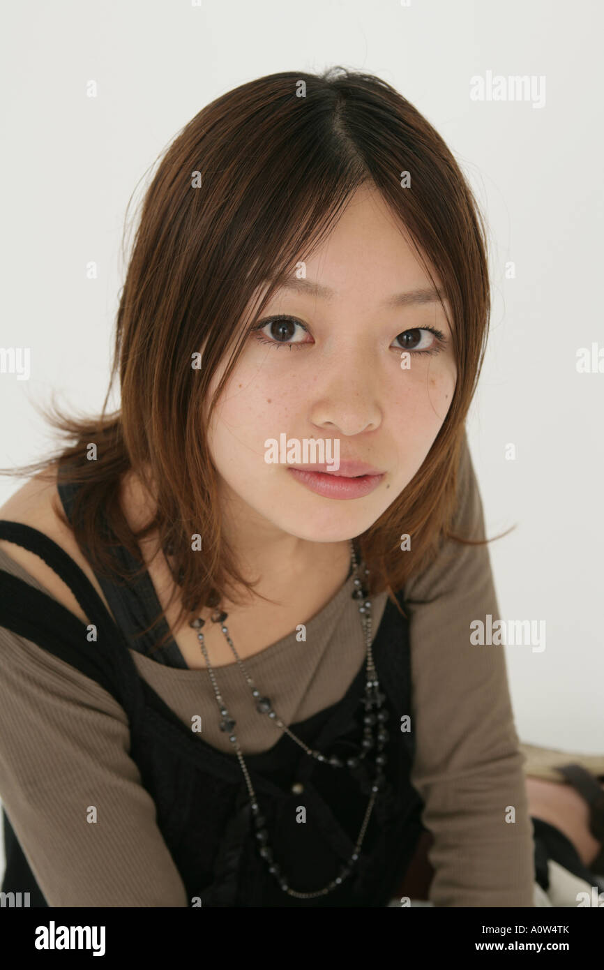Portrait of a young woman looking serious Stock Photo - Alamy