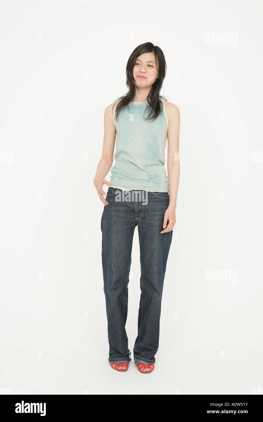Young woman standing and smiling Stock Photo - Alamy
