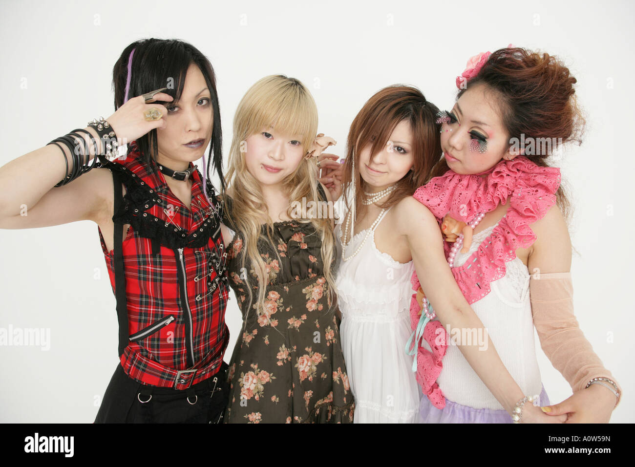 Portrait of four young women standing together and posing Stock Photo ...
