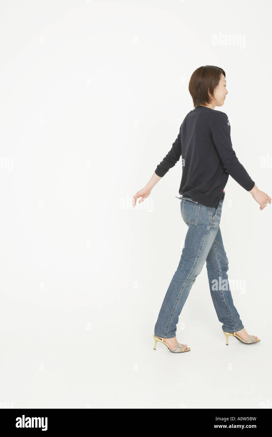 Rear view of a young woman walking Stock Photo - Alamy