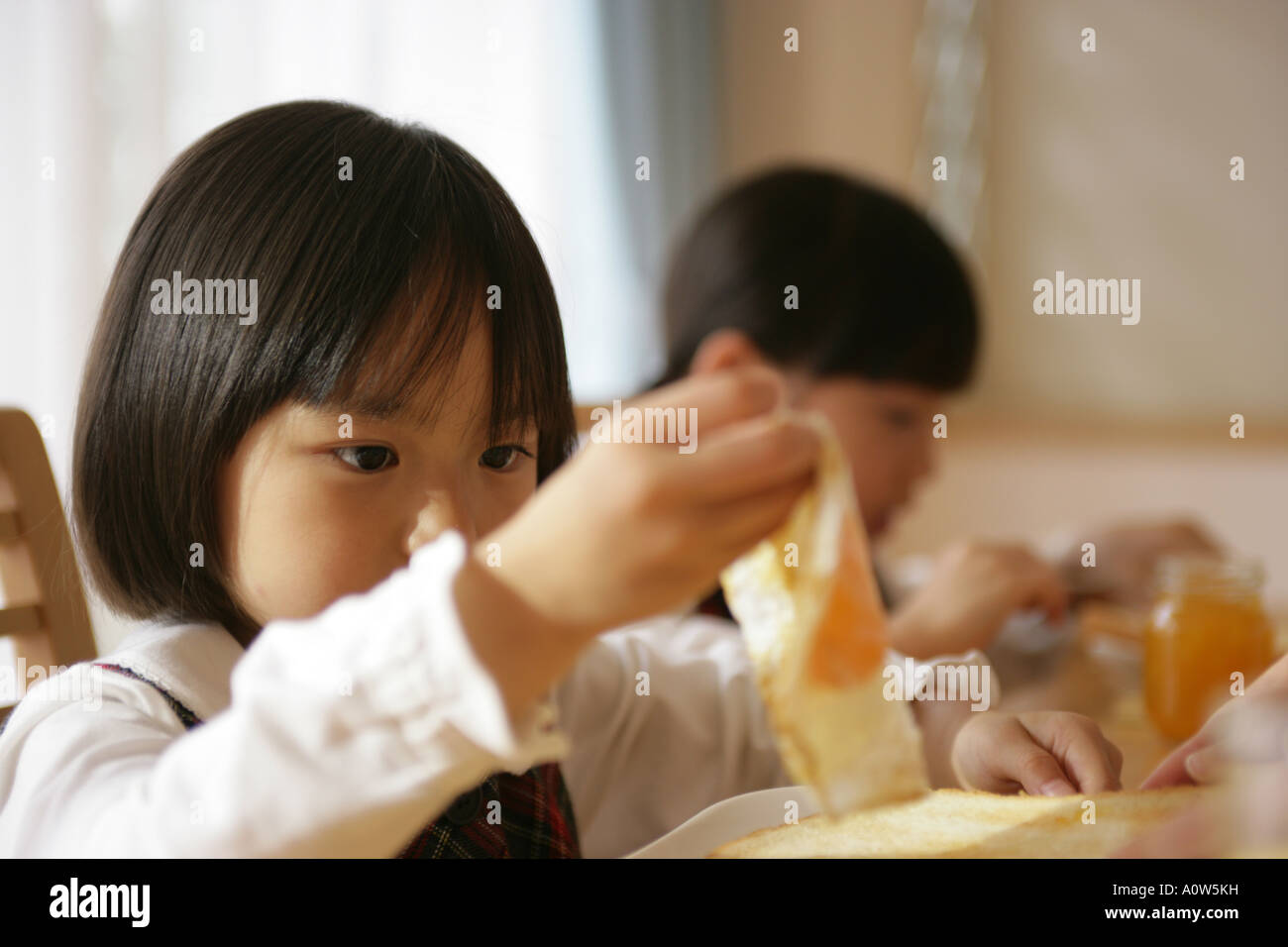 Two girls at the dining table Stock Photo - Alamy