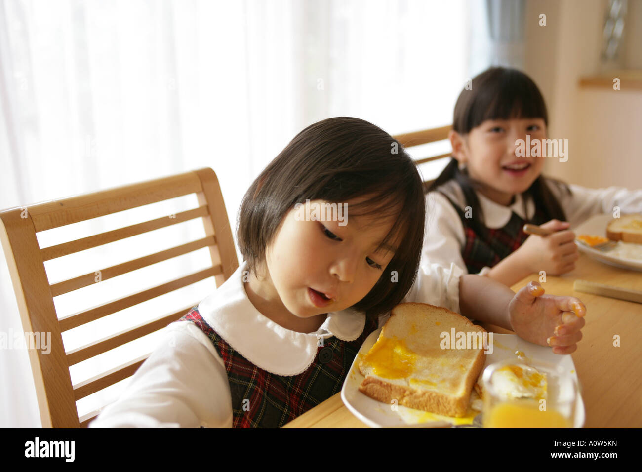 Two girls at the dining table Stock Photo - Alamy