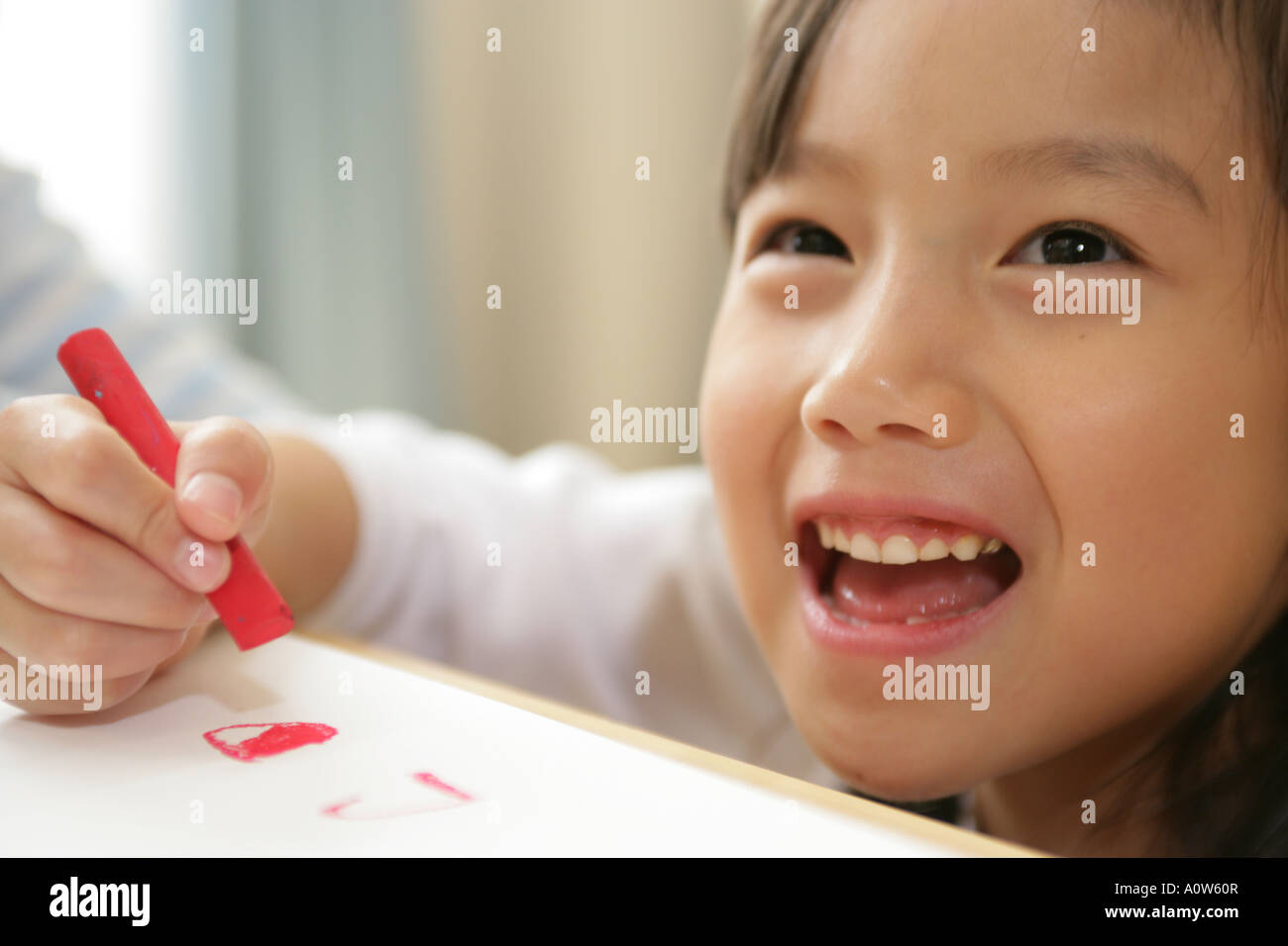 Close up of a girl drawing and laughing Stock Photo - Alamy