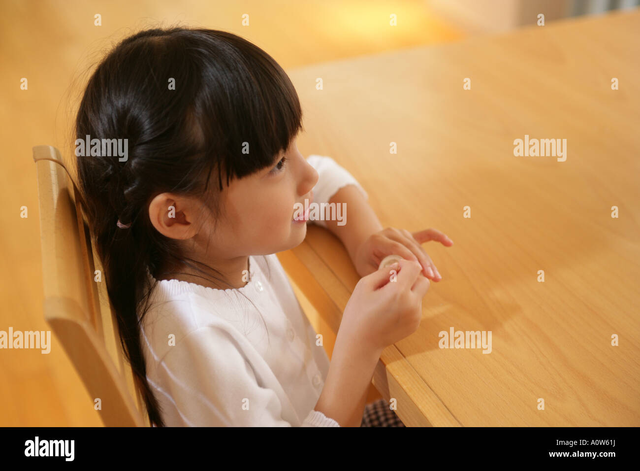 Side profile of a girl sitting at the table Stock Photo - Alamy