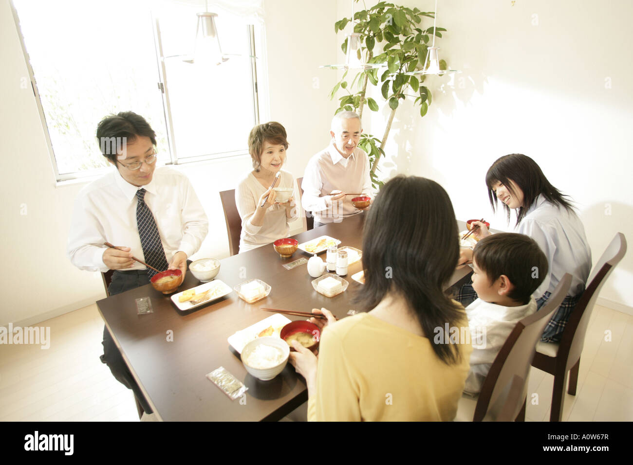 Family at the dining table Stock Photo - Alamy