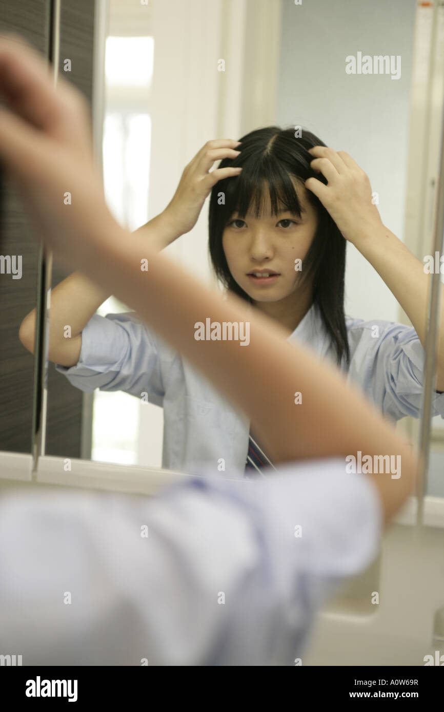 Reflection of a teenage girl in a mirror Stock Photo - Alamy