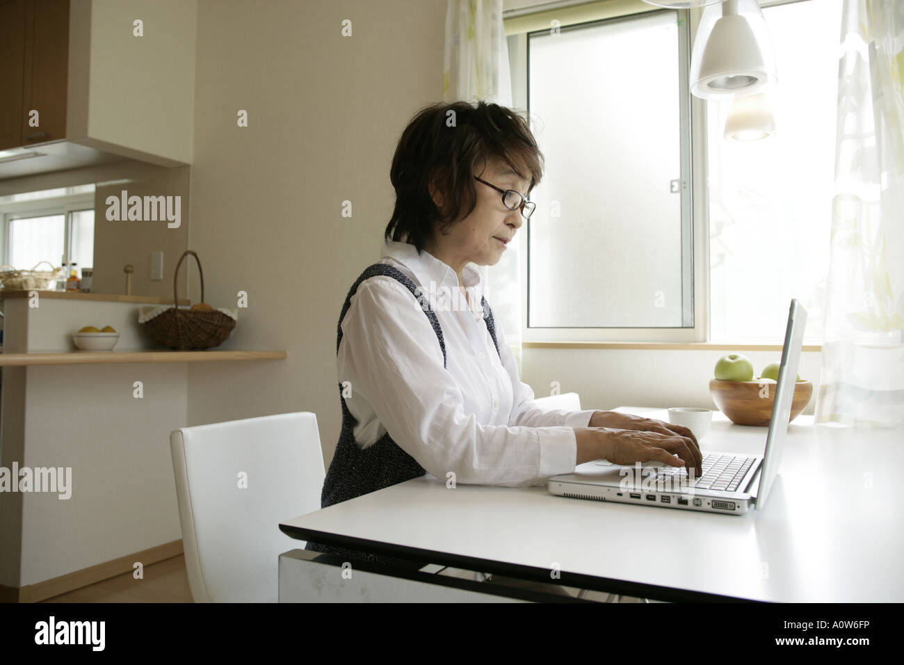 Side profile of a senior woman using a laptop Stock Photo - Alamy
